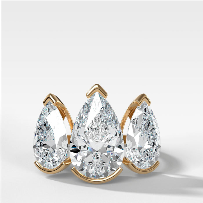 Half Bezel Triad Engagement Ring With Pear Cut Diamonds