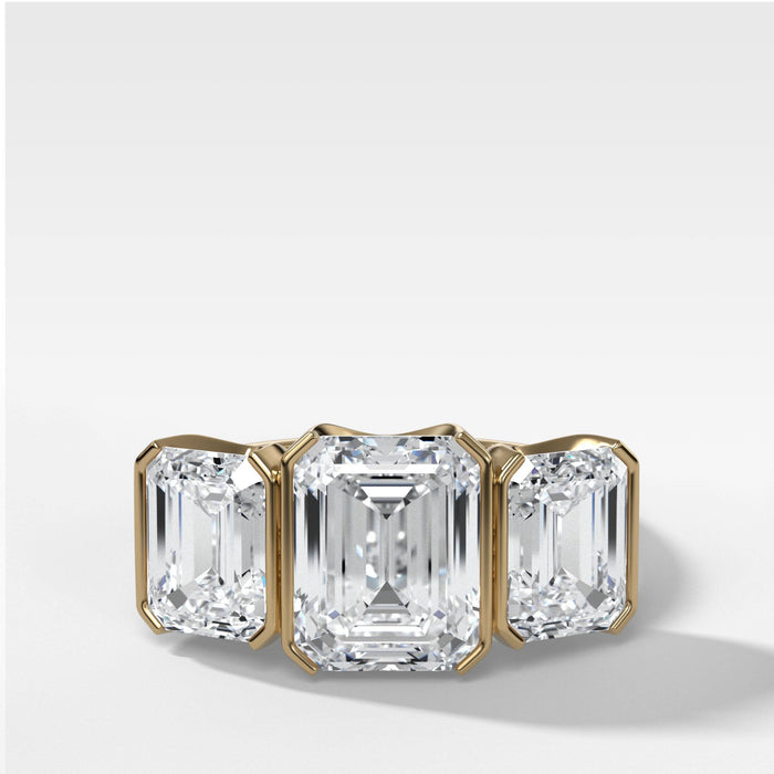 Half Bezel Triad Engagement Ring With Emerald Cut Diamonds
