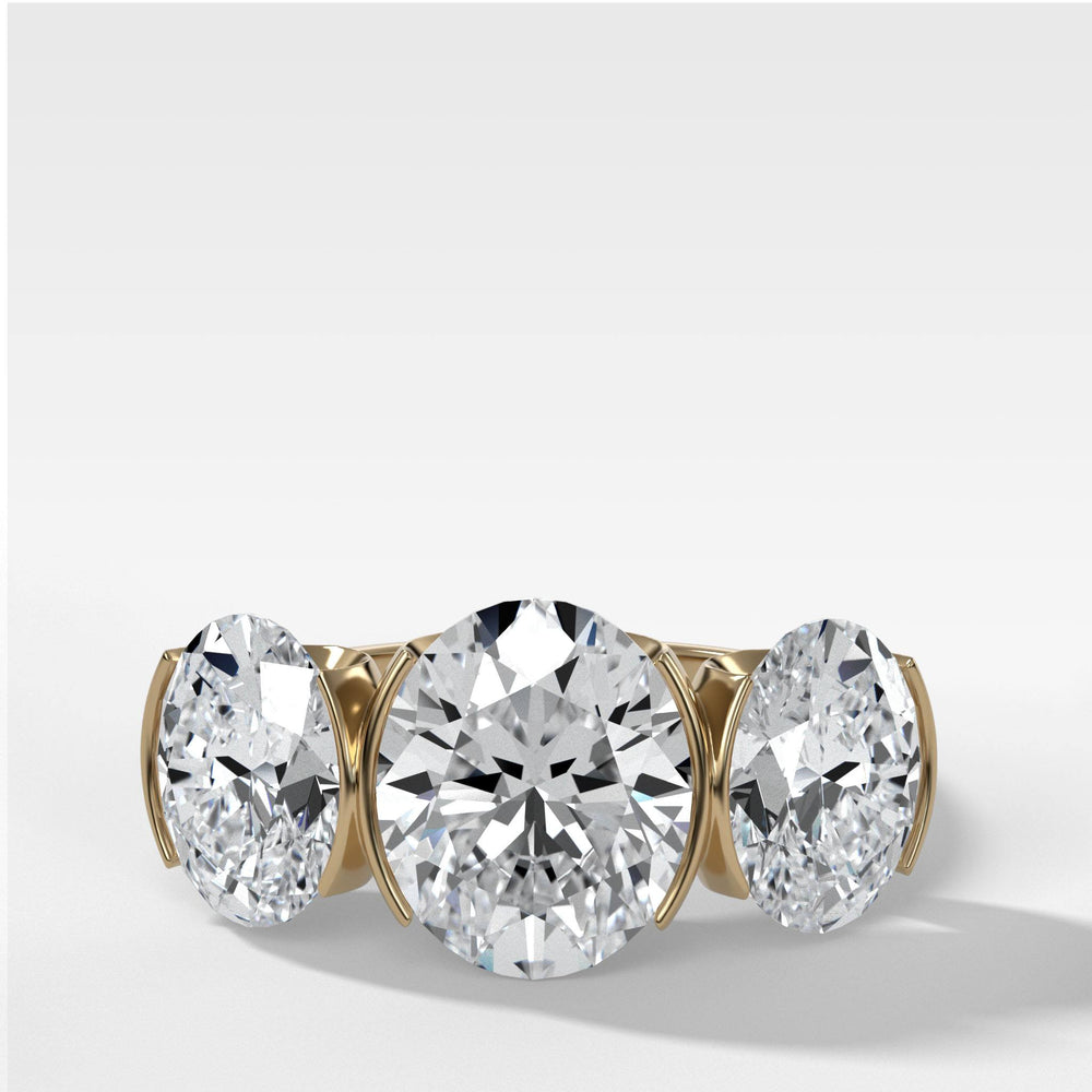 Half Bezel Triad Engagement Ring With Oval Cut Diamonds